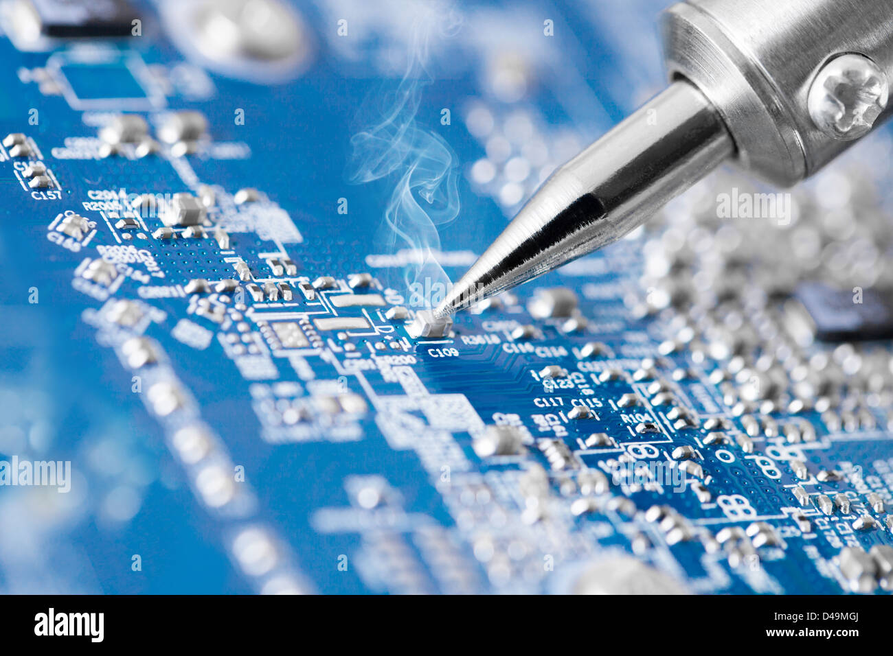 Microcircuit being fixed with soldering iron - very sharp micro photo ...