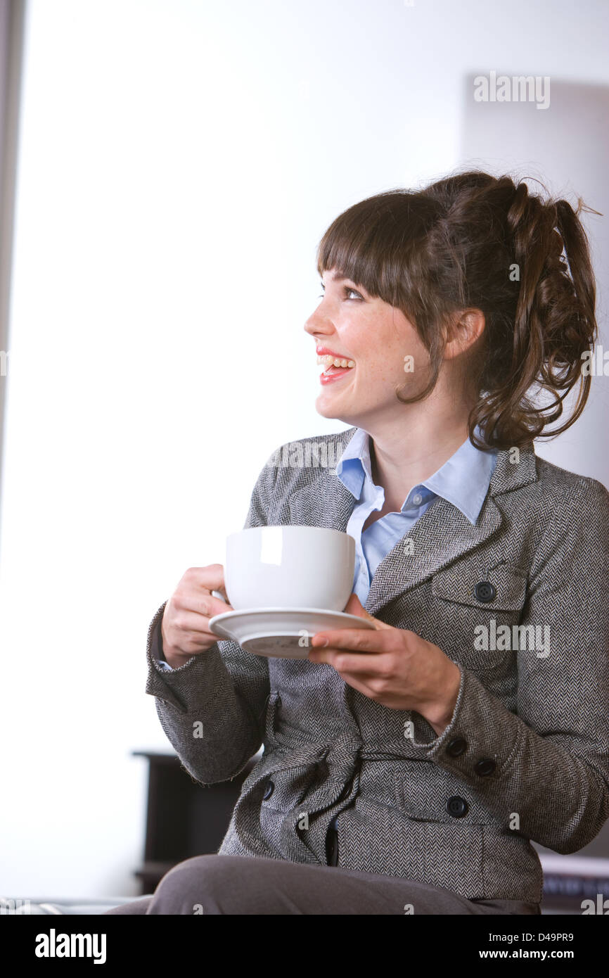 BUsiness woman having her morning coffee Stock Photo - Alamy