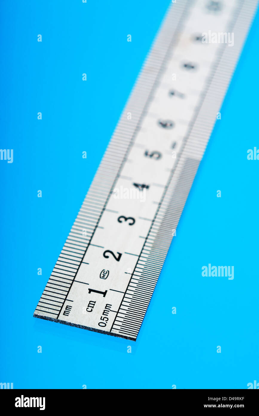 This is an image of a ruler, cut out over a blue background Stock Photo ...