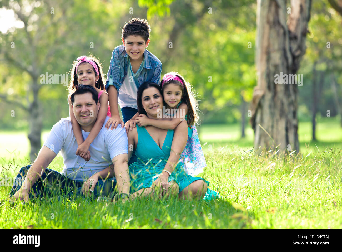 Happy family having fun outdoors in spring green park Stock Photo - Alamy