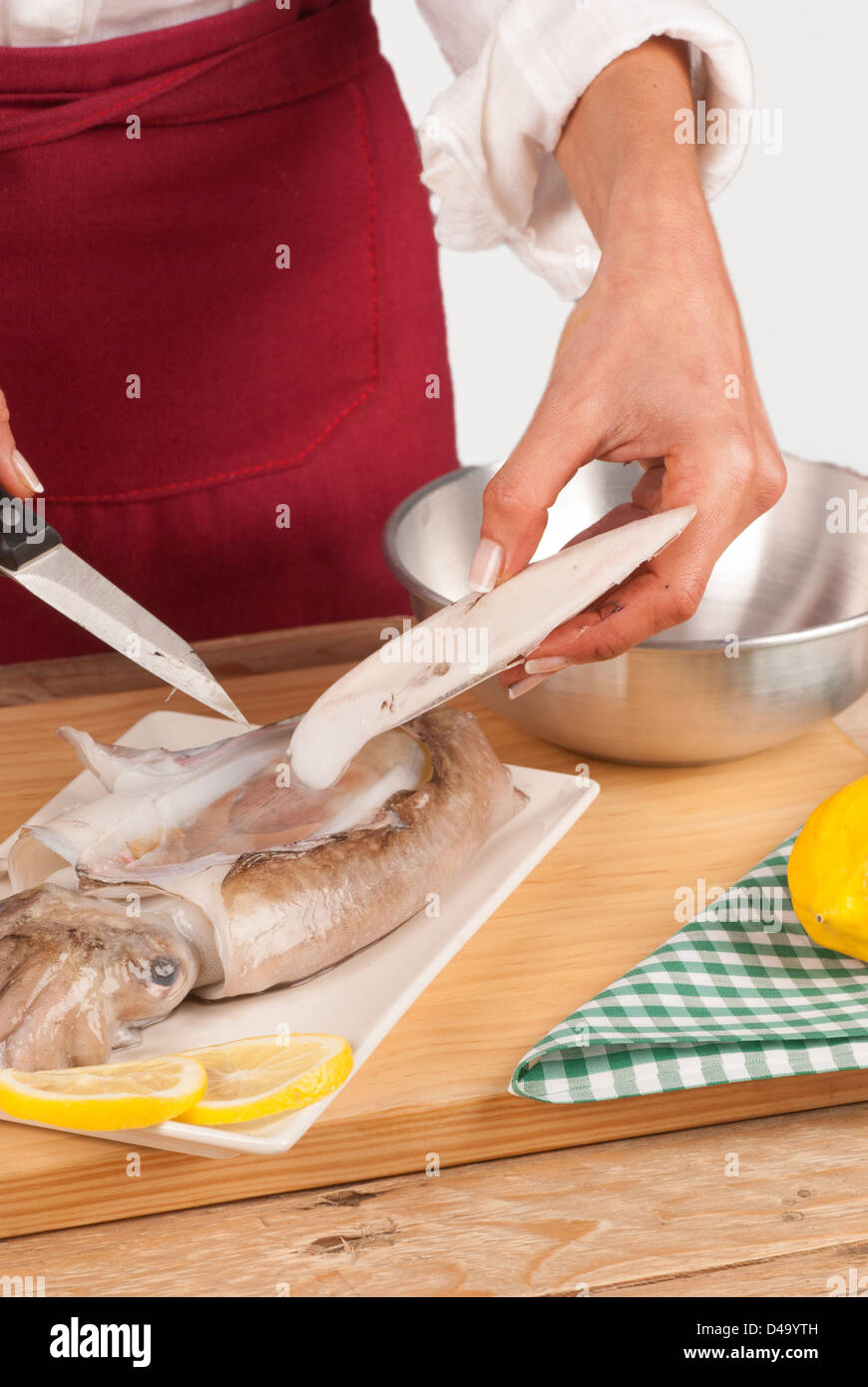 Cleaning a cuttlefish to be cooked Stock Photo - Alamy