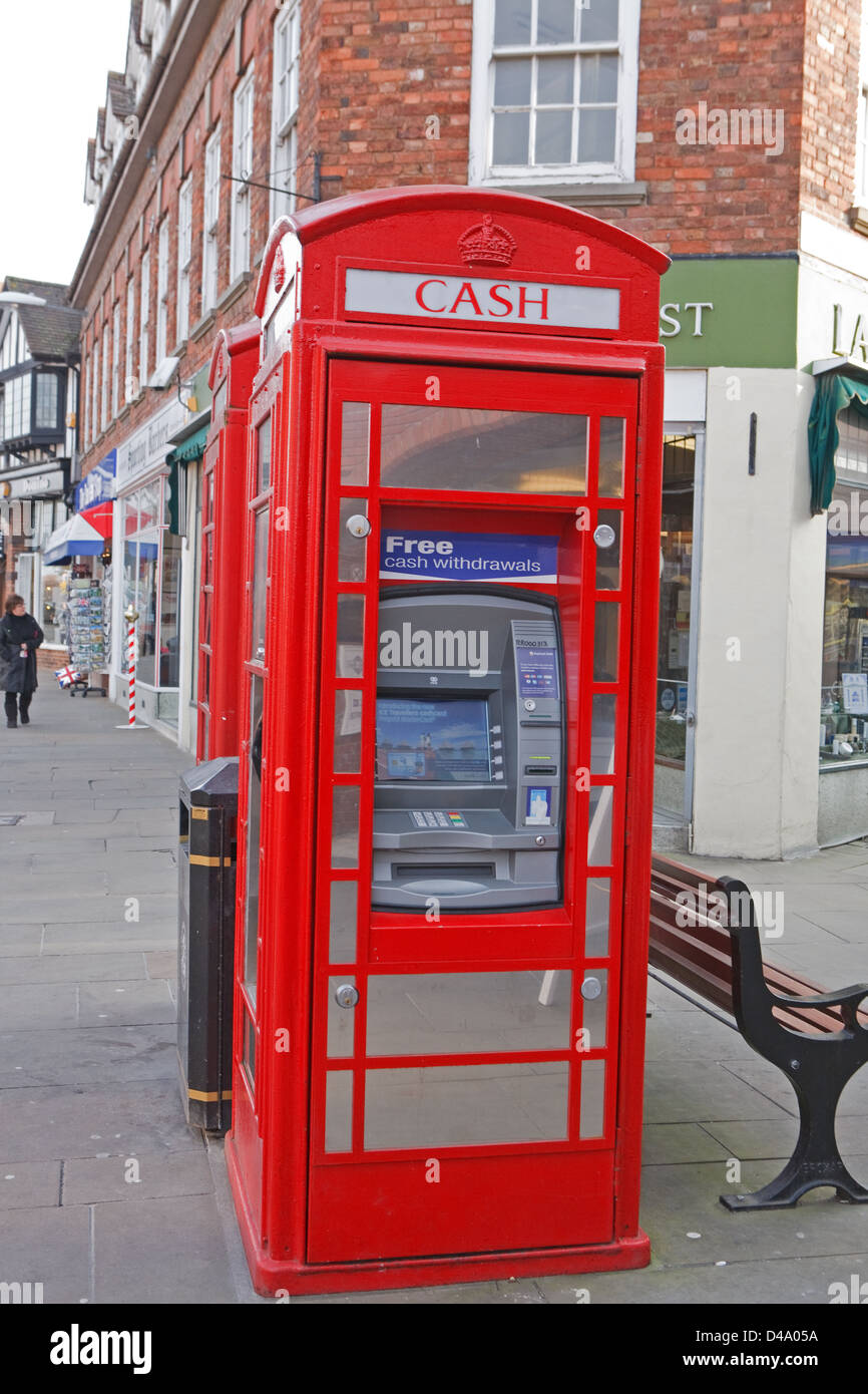 Old red telephone boxes converted to a cash machine with telephone ...