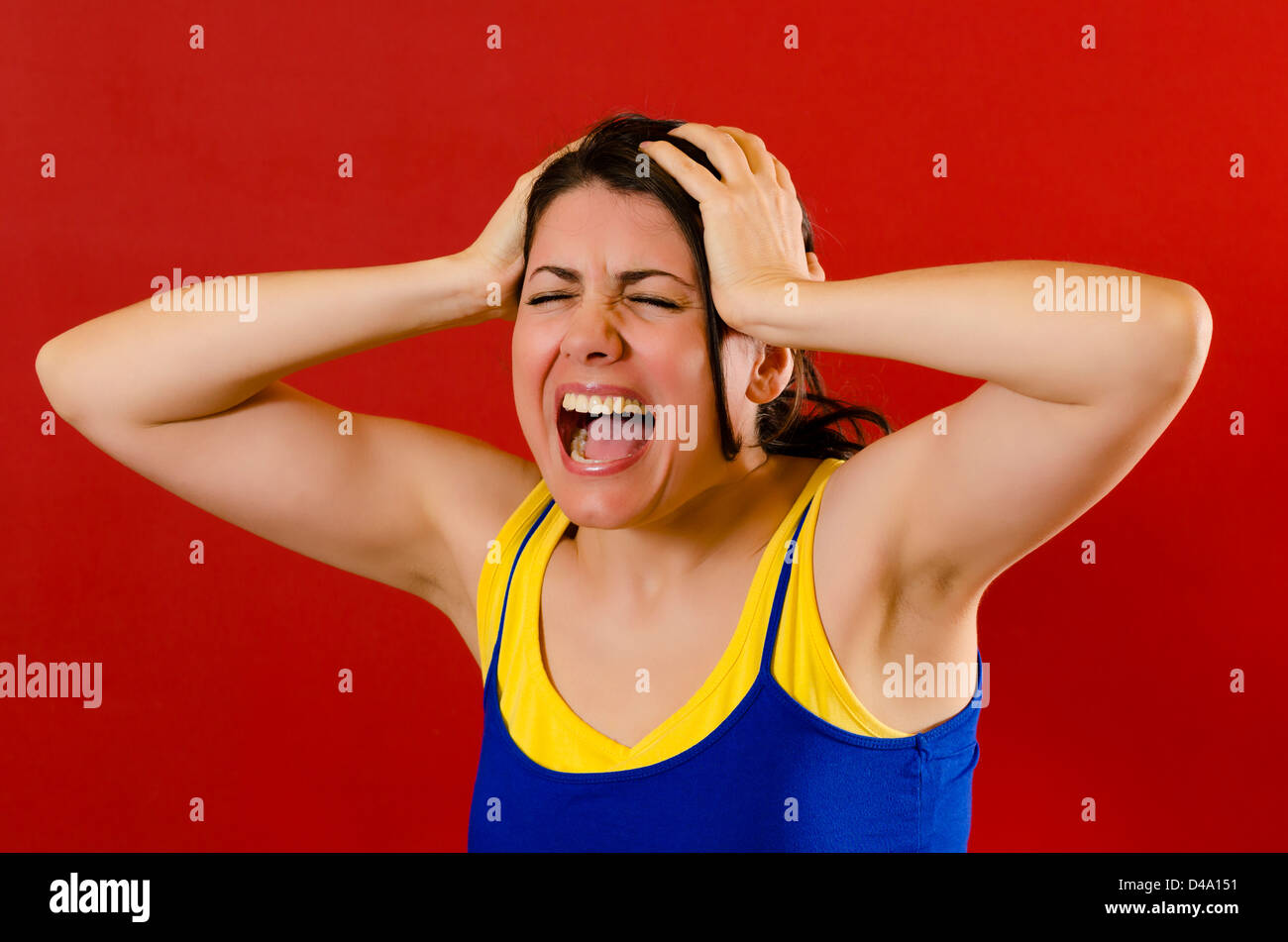 Angry woman screaming loud , isolated on red Stock Photo - Alamy