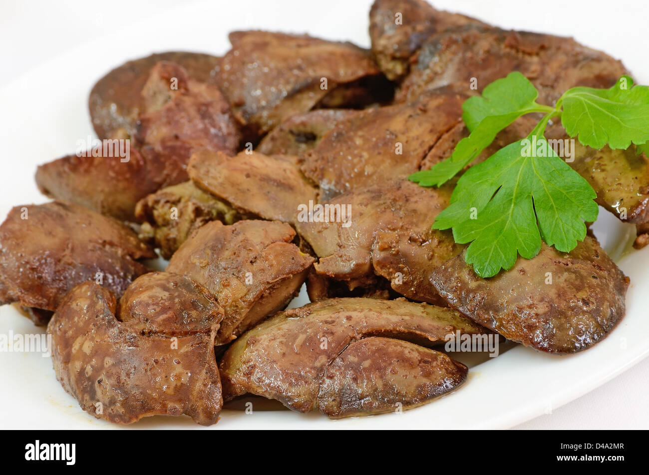 Close up cooked chicken liver on a white plate Stock Photo - Alamy