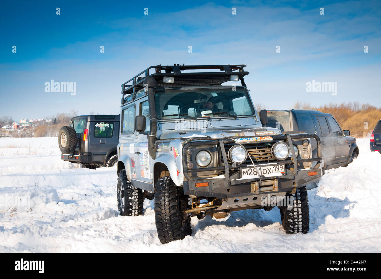 Blue Land Rover Defender 90 suv front on background the Russian winter ...