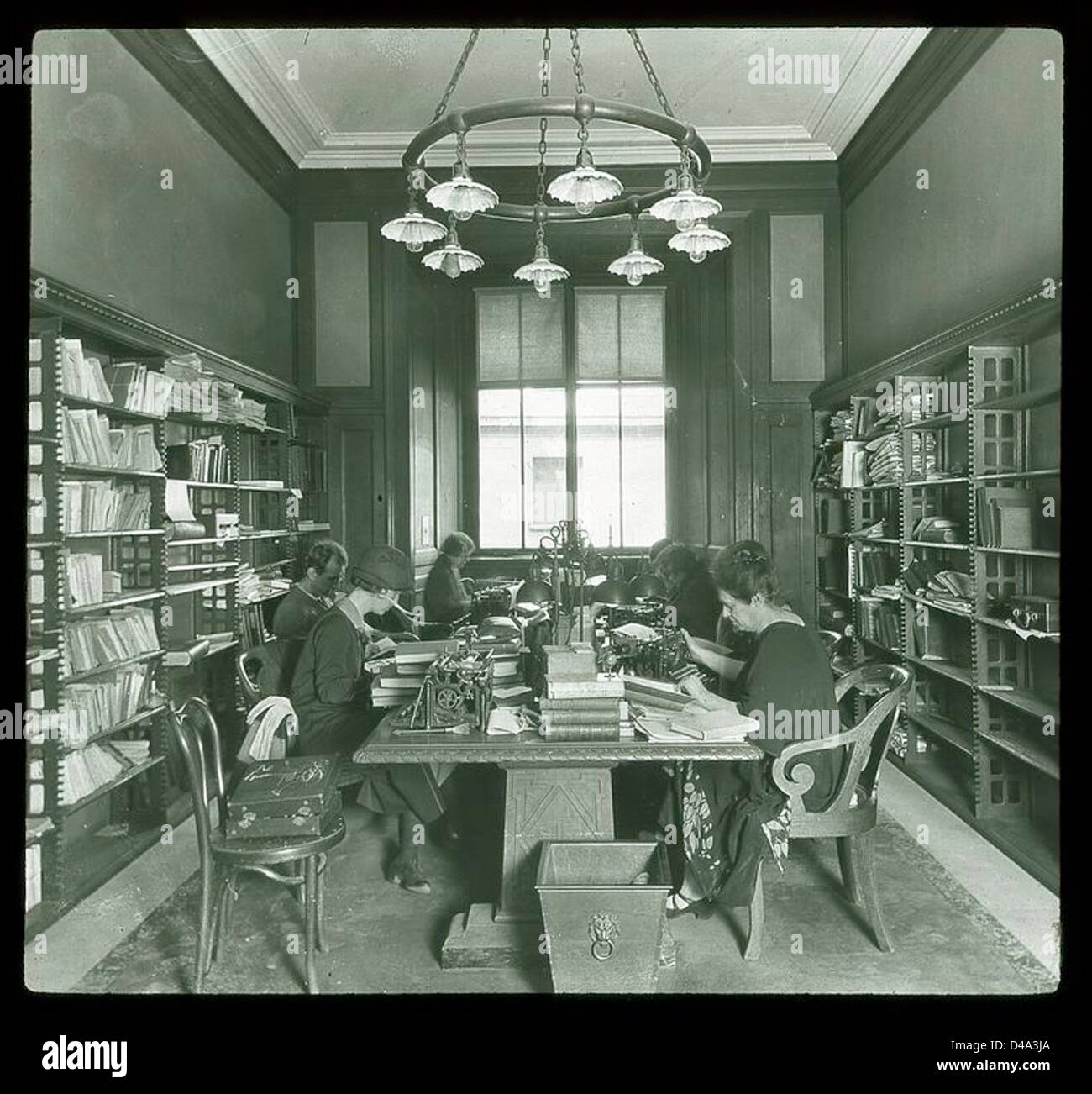 This 1926 photograph shows a typical study and typing room, featuring ...