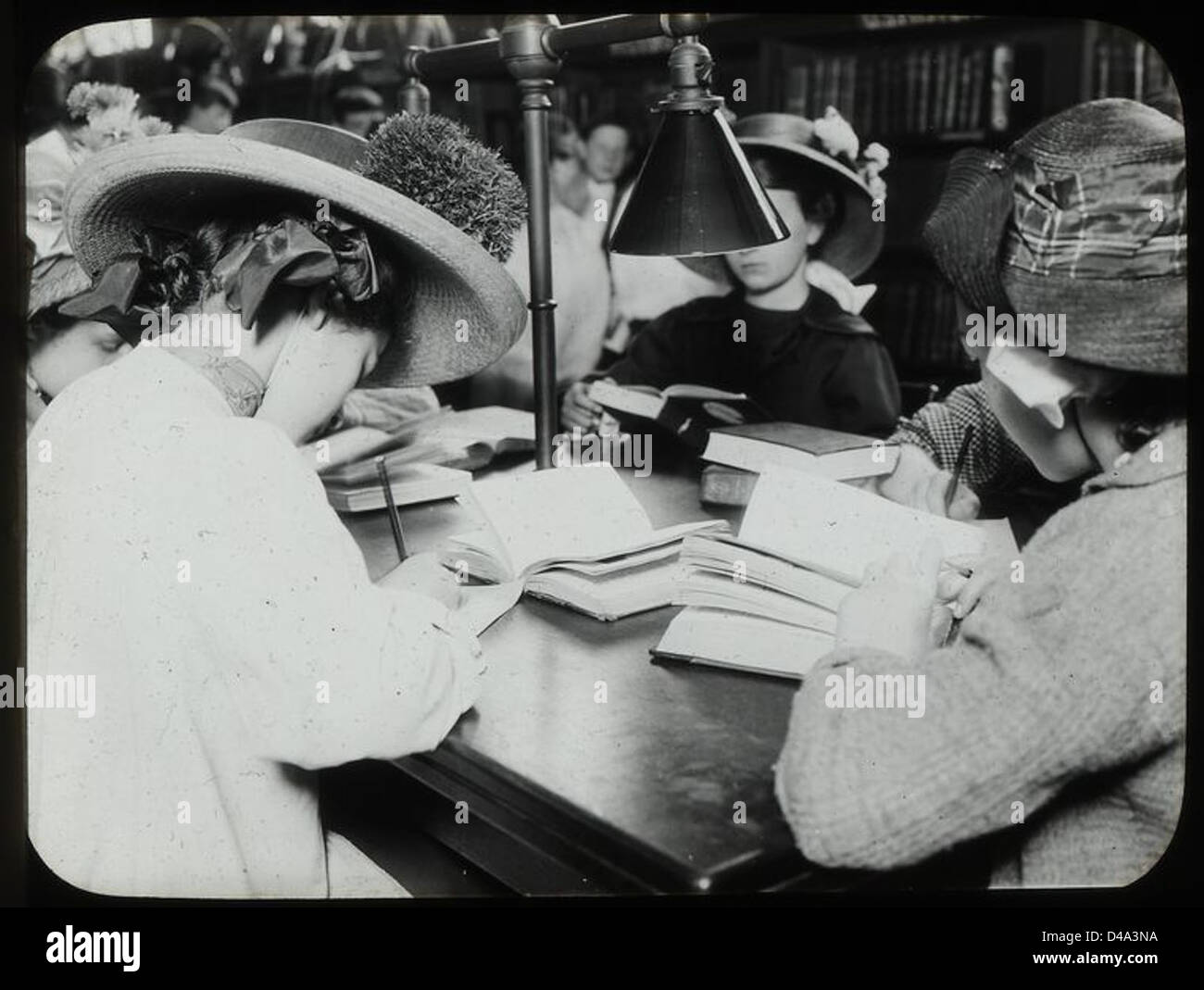 Work with schools : writing a composition : girls each weari Stock ...