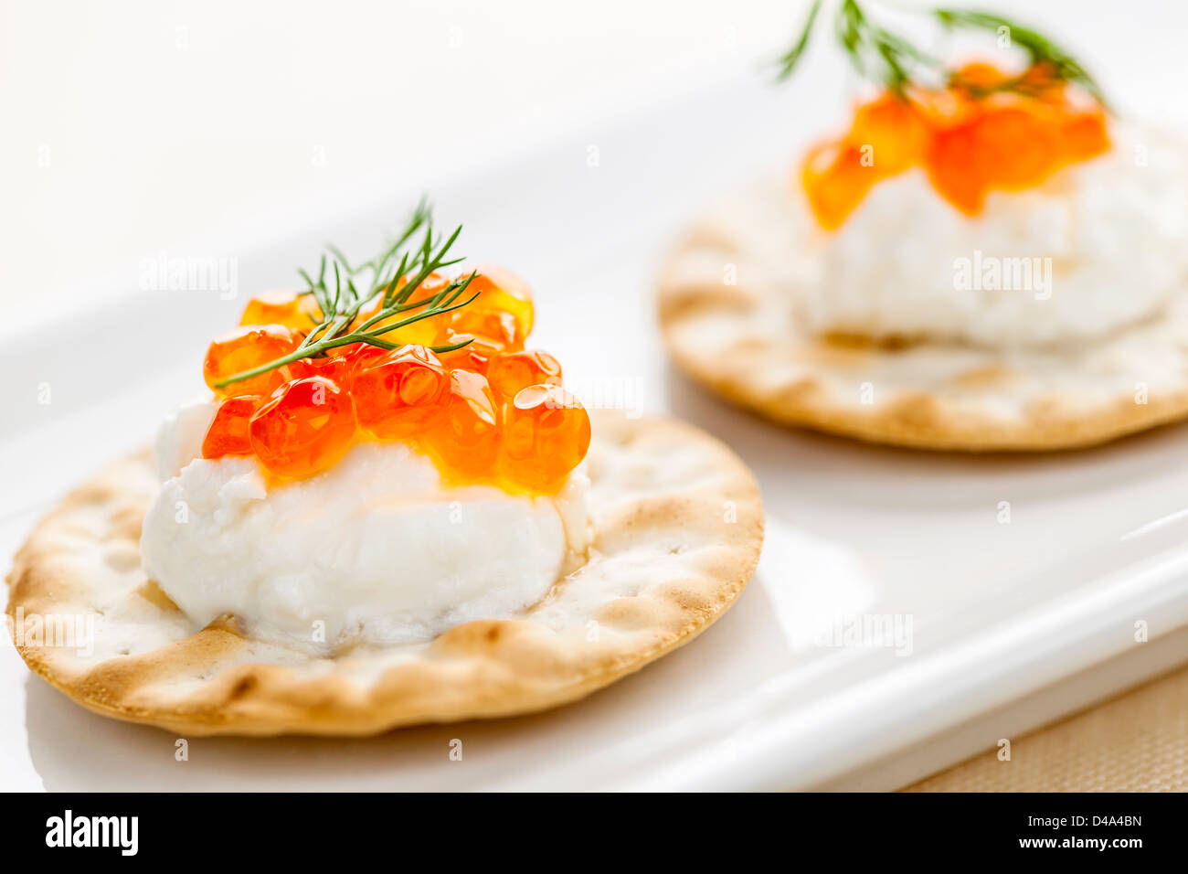 Closeup of caviar and cream cheese appetizer on crackers Stock Photo ...