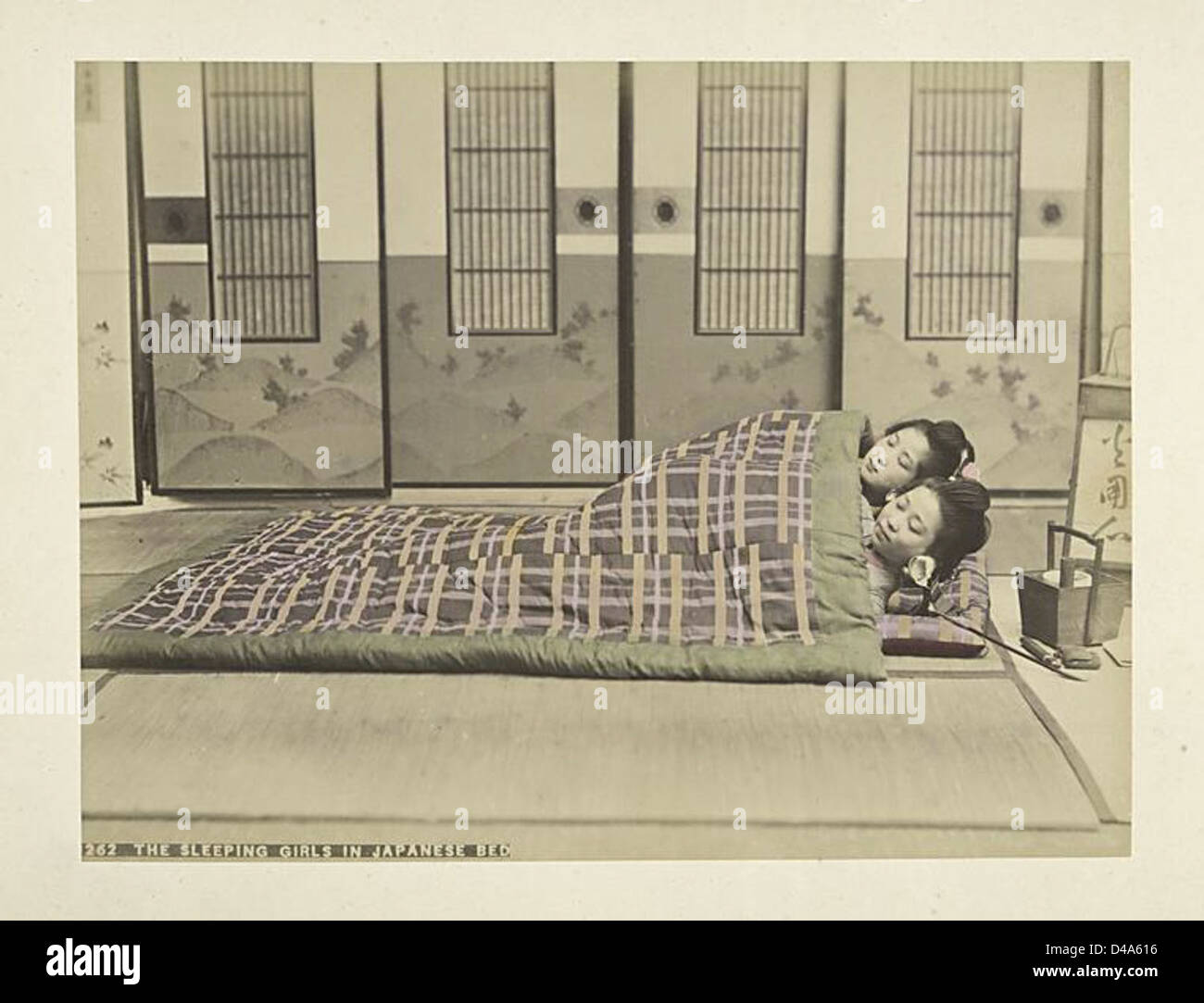 This image depicts sleeping girls in a traditional Japanese bed ...