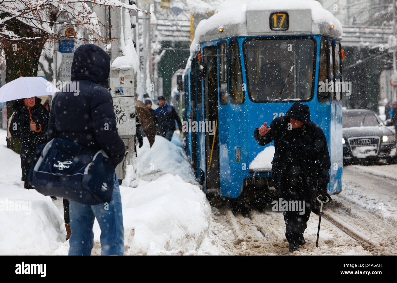 Tram driver is cleaning rails on tram stop in heavy snow Stock Photo ...