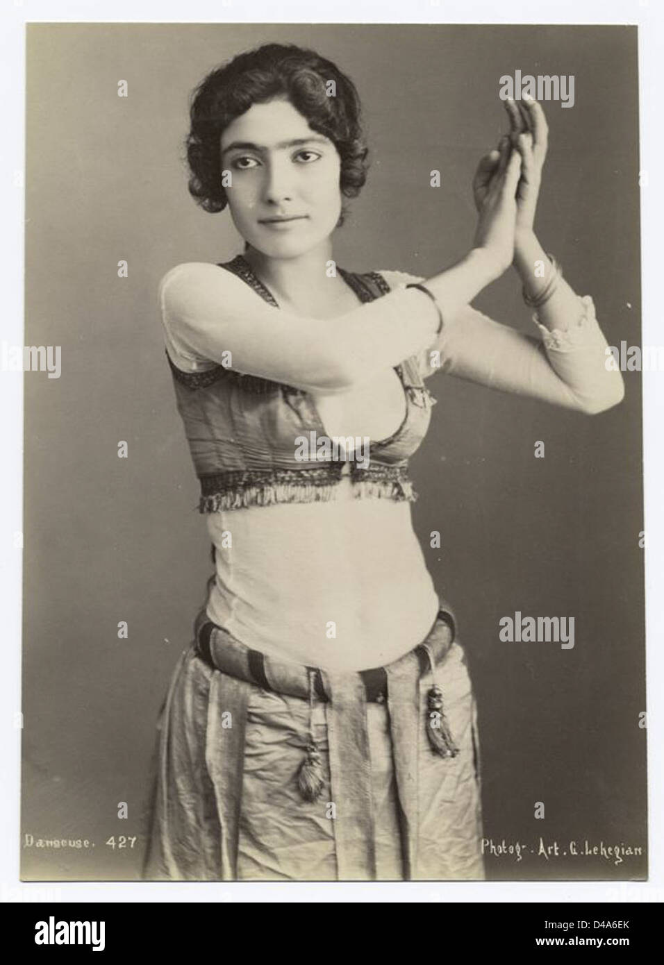 This portrait features an Egyptian dancer in traditional costume ...
