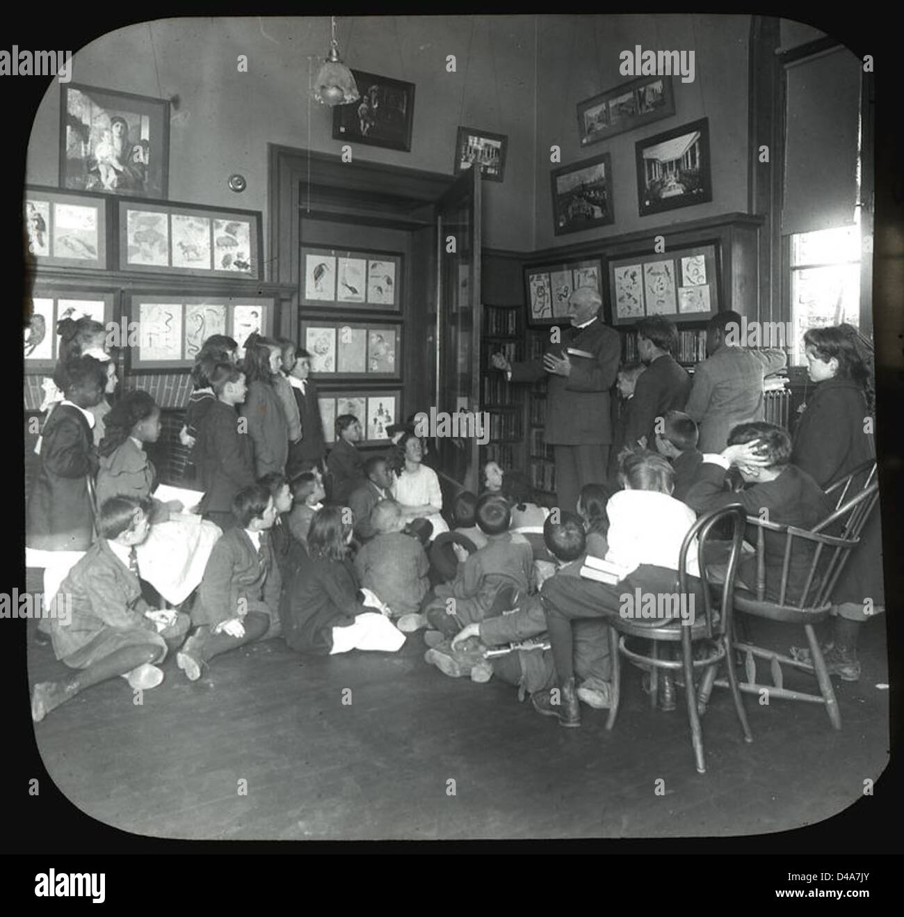 This 1913 photograph shows Dan Beard telling a story to a group of ...