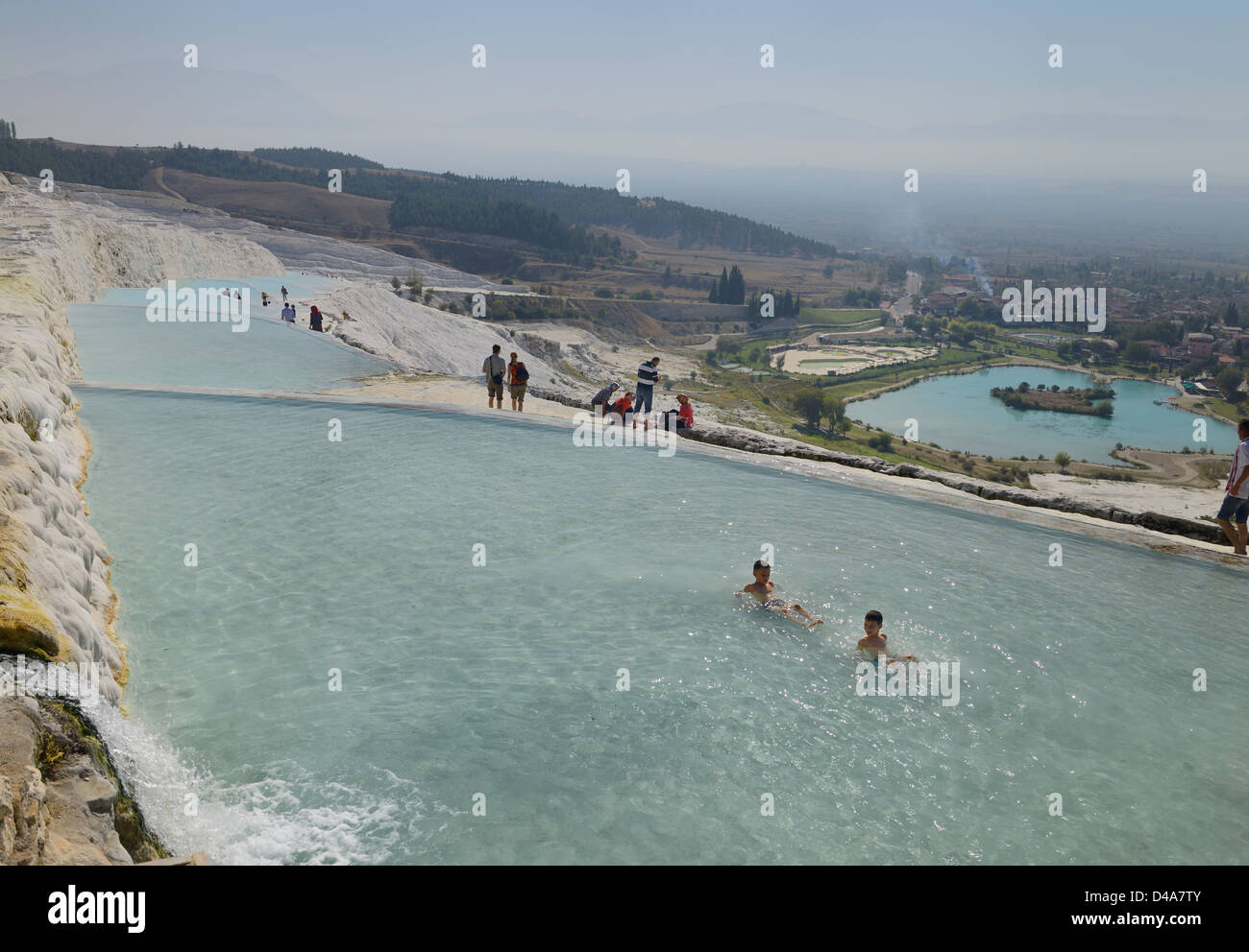Mineral water flowing into hot spring pools depositing travertine ...