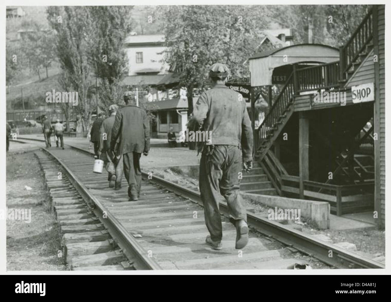 This photograph depicts coal miners returning home from work in Omar ...