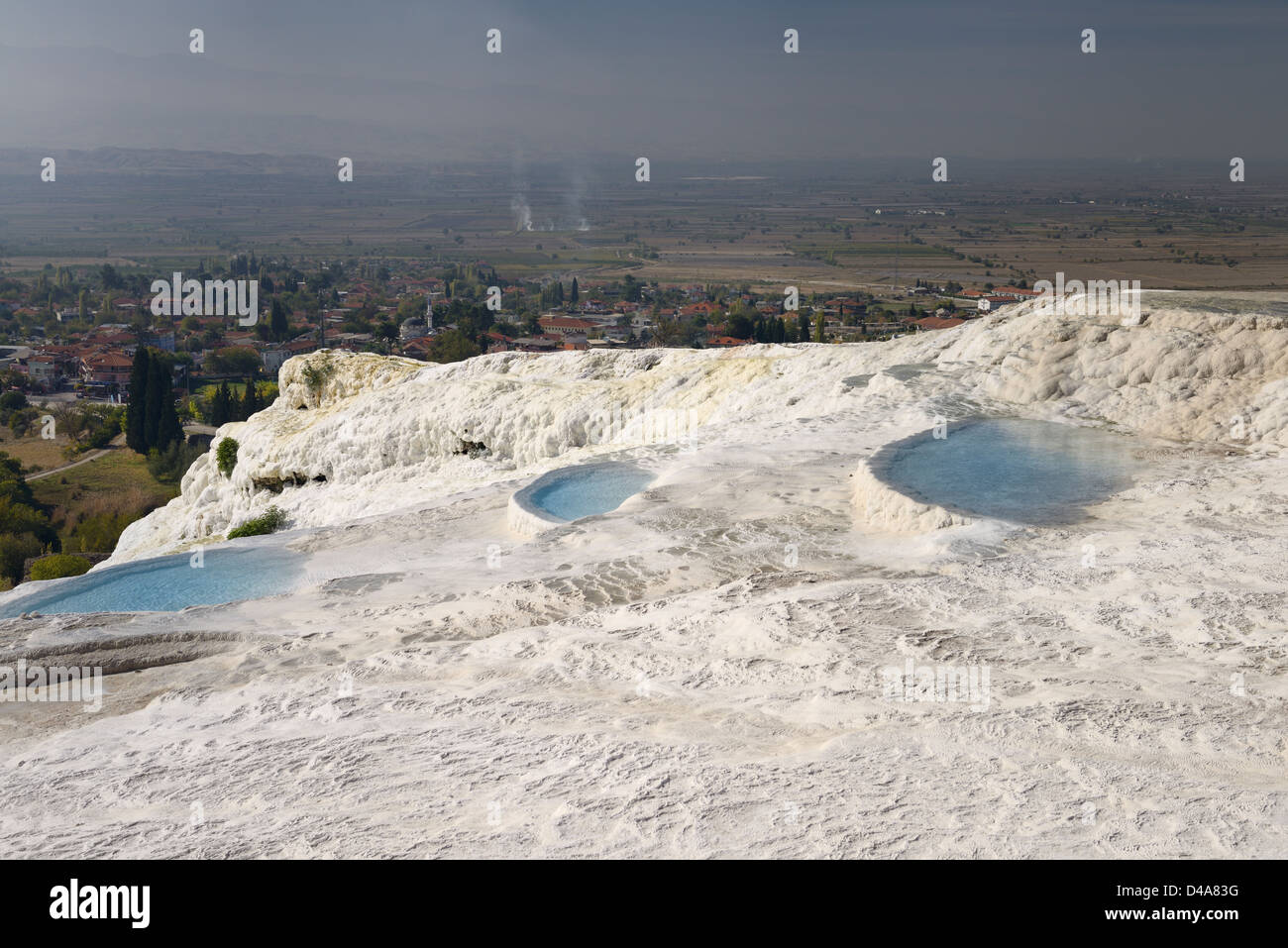 Blue hot spring pools depositing white calcium carbonate mineral ...