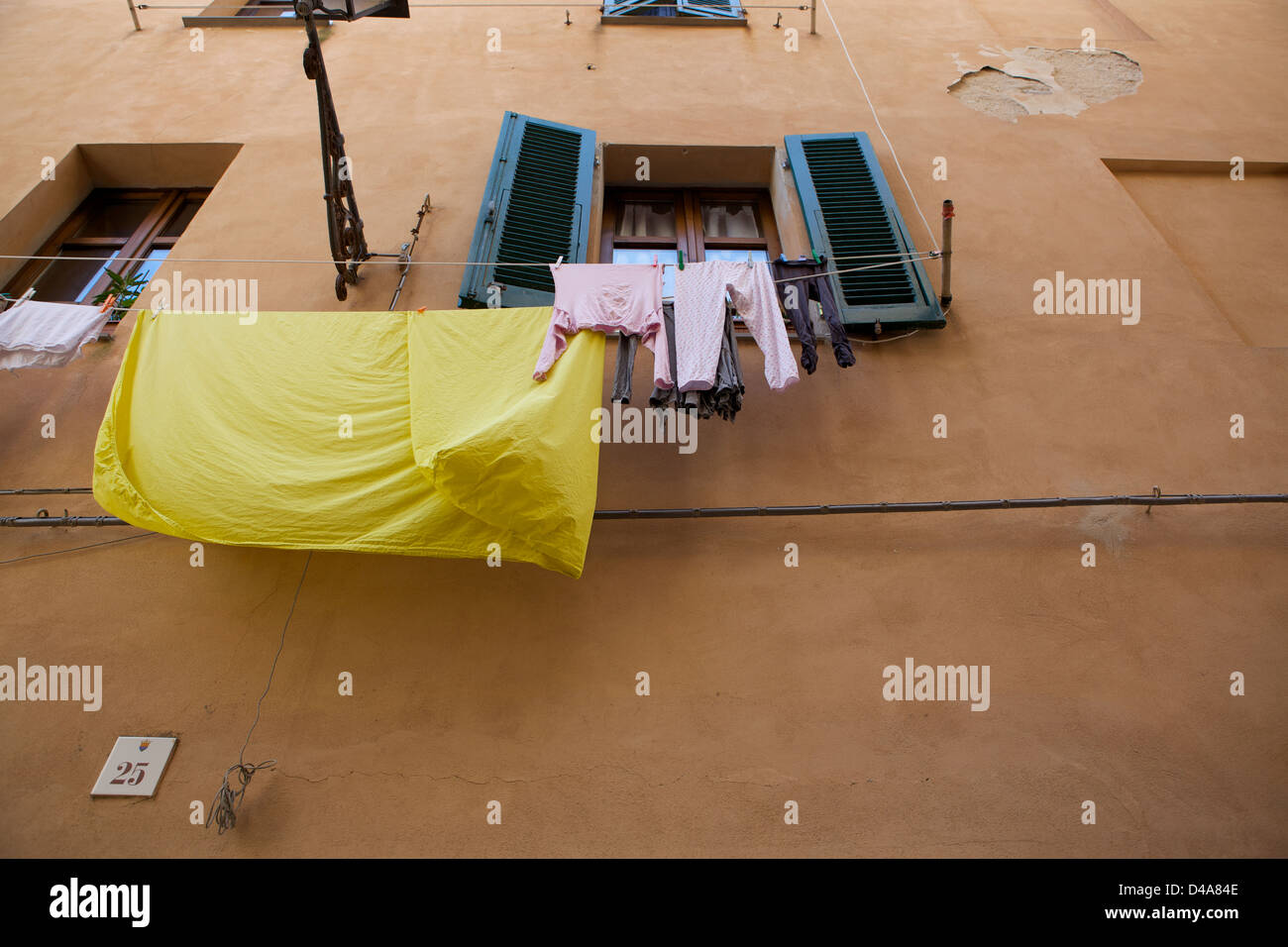 Laundry hanging on a washing line outside a window in Alghero, Sardinia ...