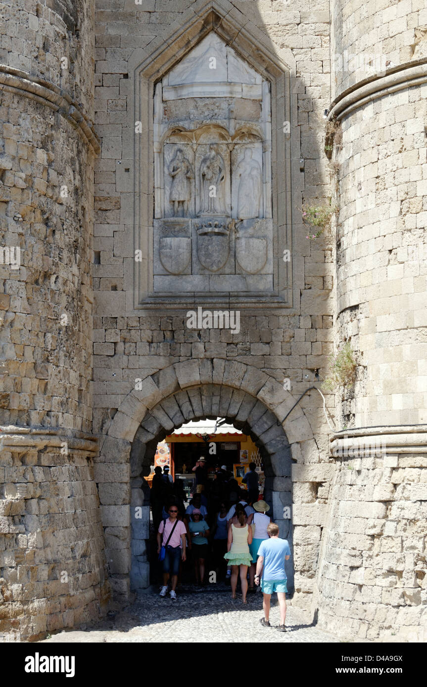 Rhodes. Greece. Tourists walking through the Marine Gate which forms ...