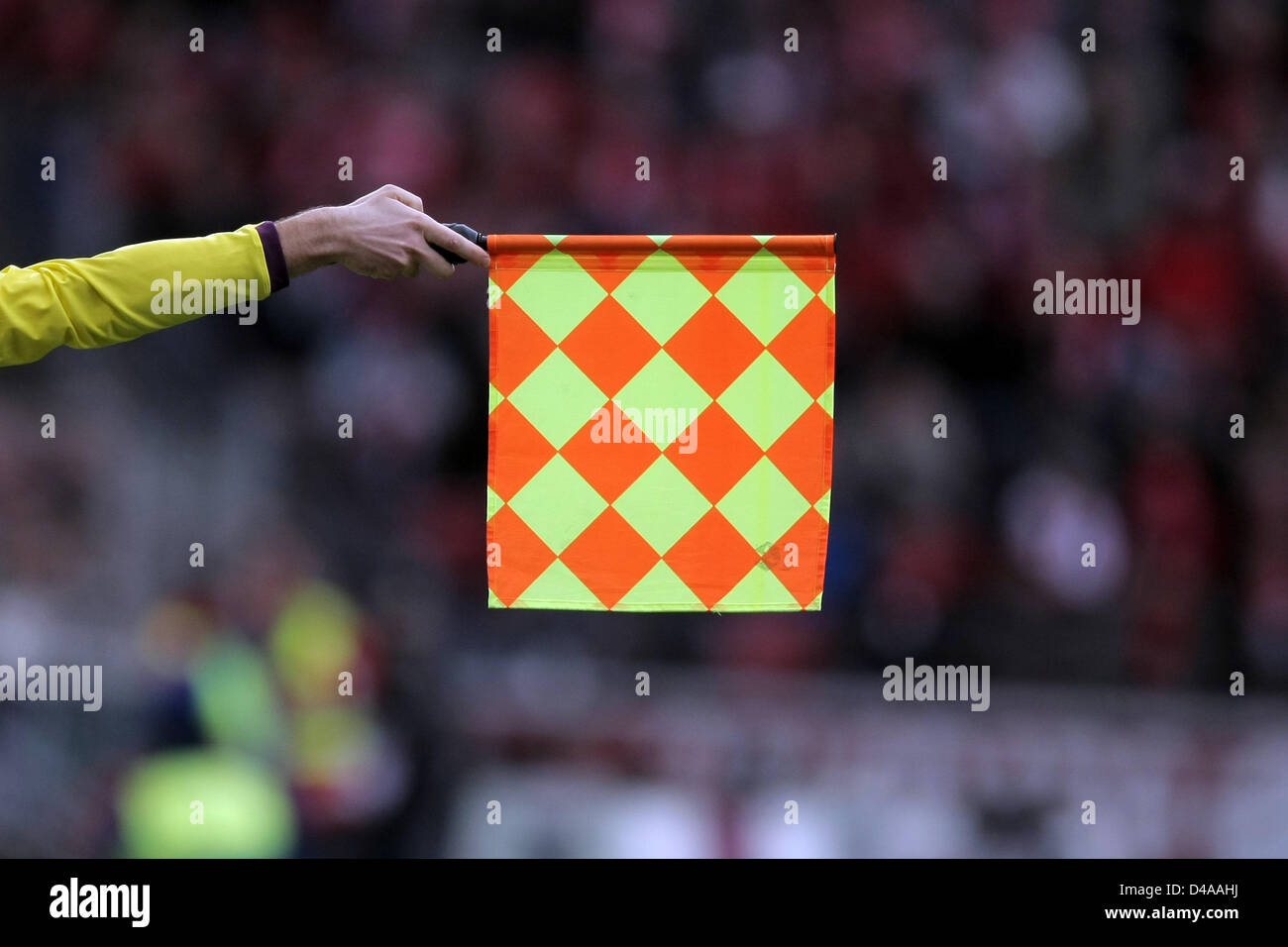 An assistant referee indicates an offside position with a flag during ...