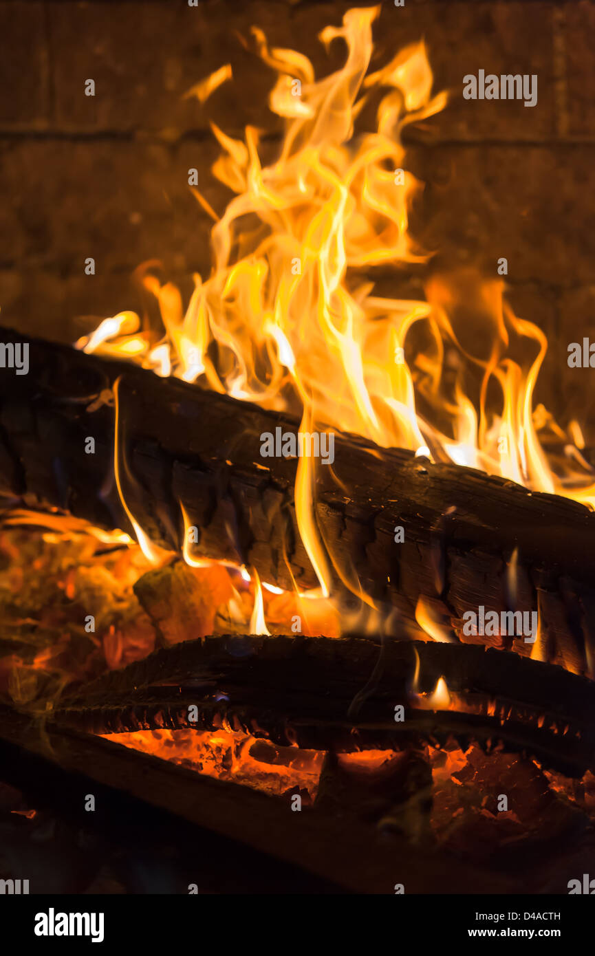Burning firewoods ember in fireplace Stock Photo - Alamy