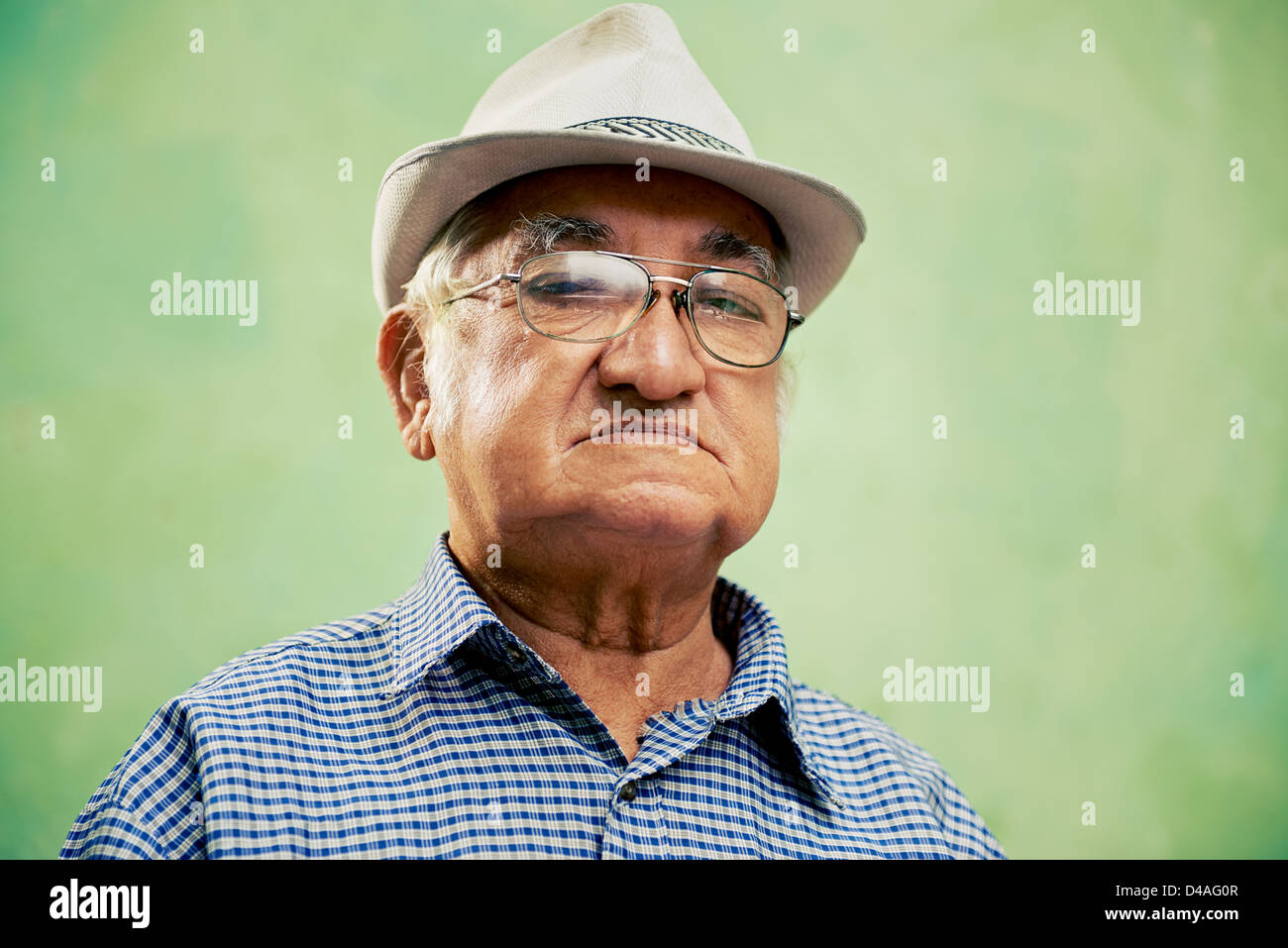 people and emotions, portrait of serious senior hispanic man with ...