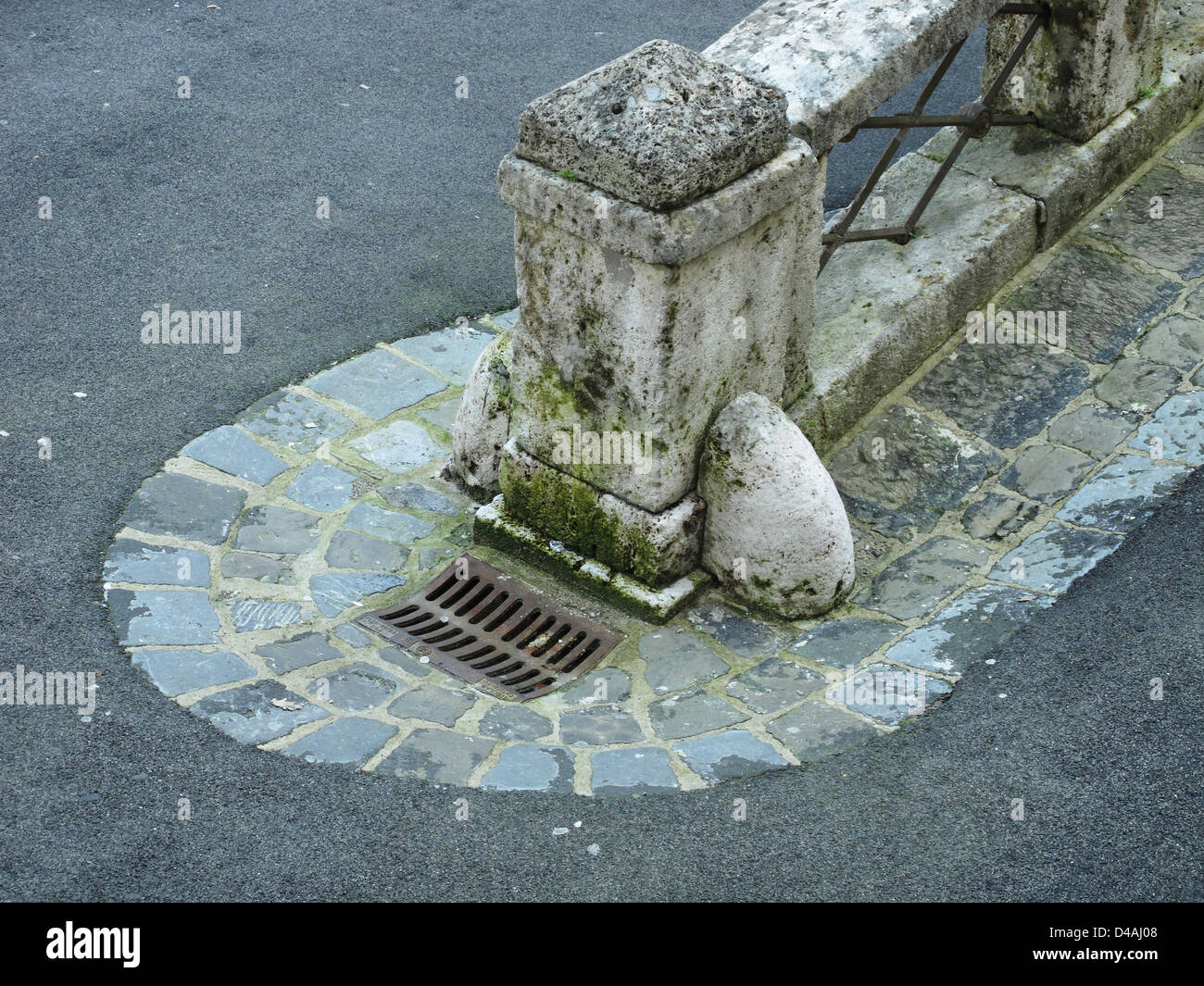 Manhole in a curve with asphalt and banister Stock Photo - Alamy