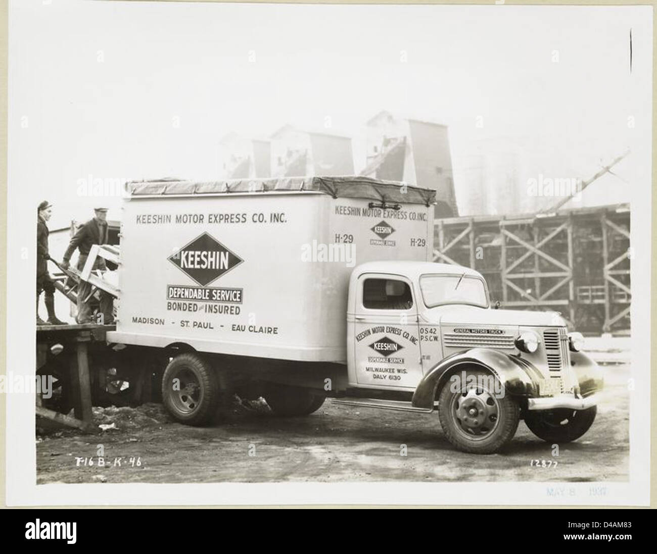 This 1930s photograph shows men loading furniture into a Keeshin Motor ...