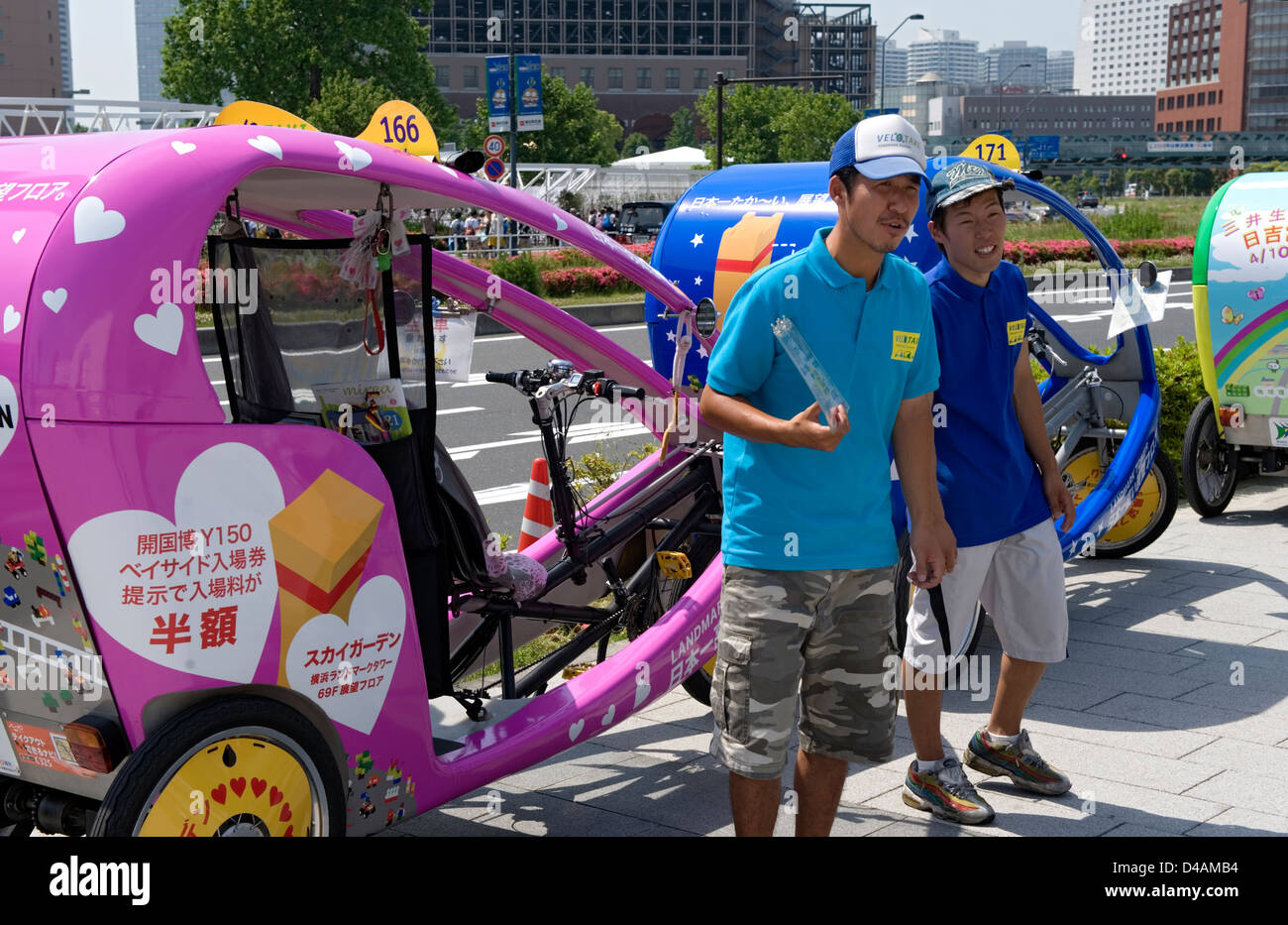 Colorful velo taxis line up along the Yokohama waterfront awaiting ...