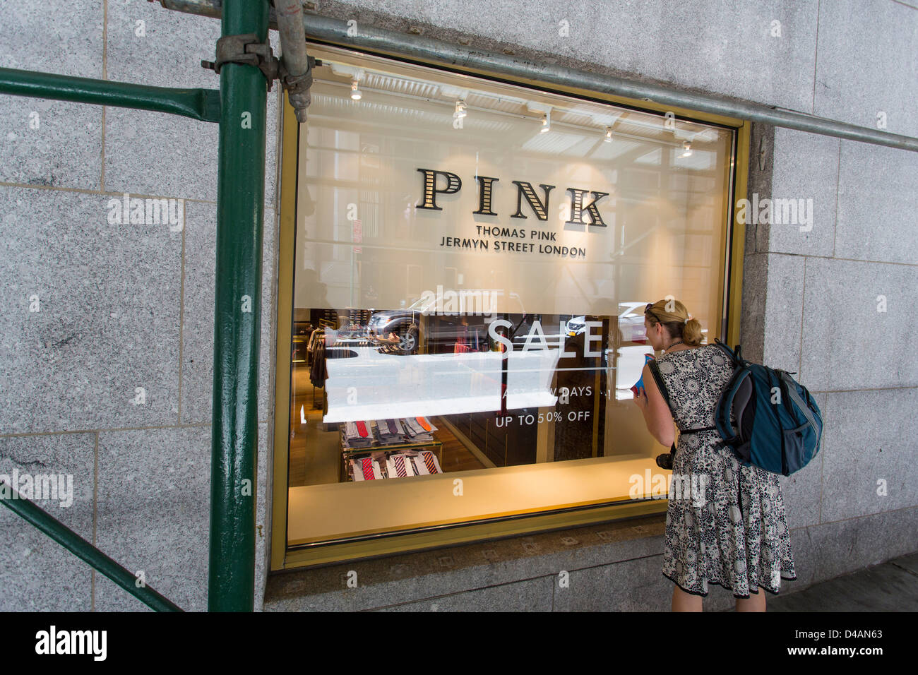 Young lady looking at the windows display of the PINK store in ...
