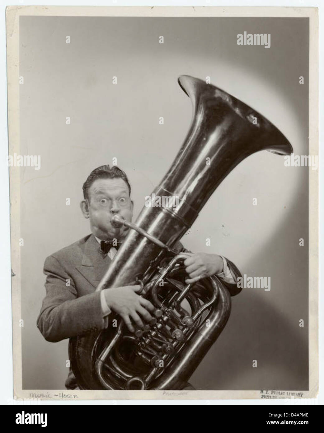 This photograph shows Fred Allen playing the tuba, showcasing the ...