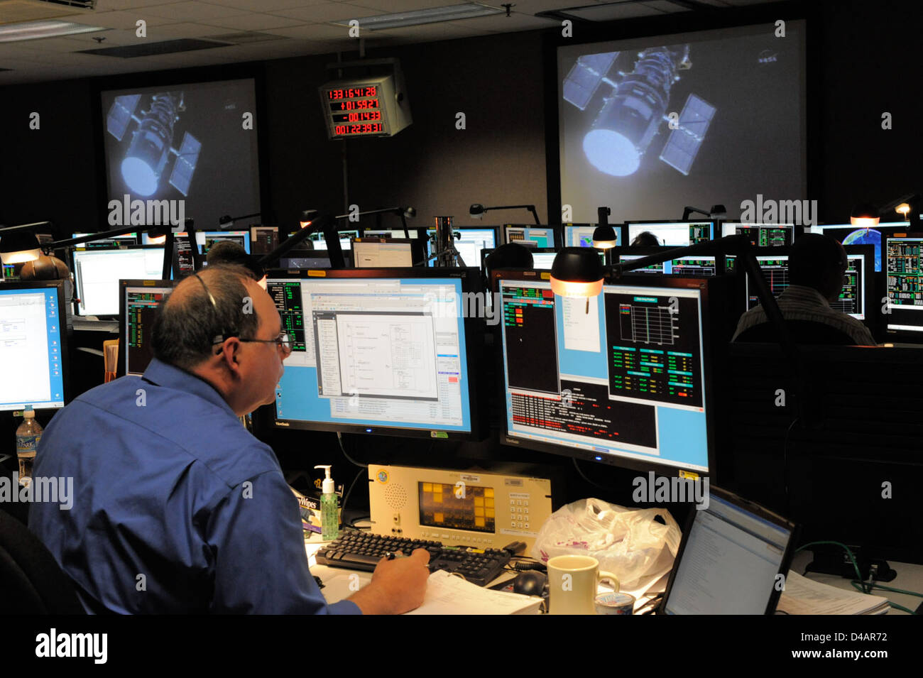 NASA engineers at the Goddard Space Flight Center are seen grappling ...