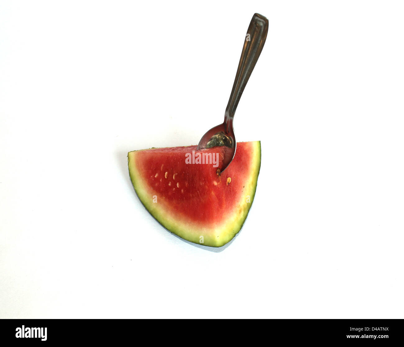 A cut watermelon with spoon, ready to eat Stock Photo - Alamy