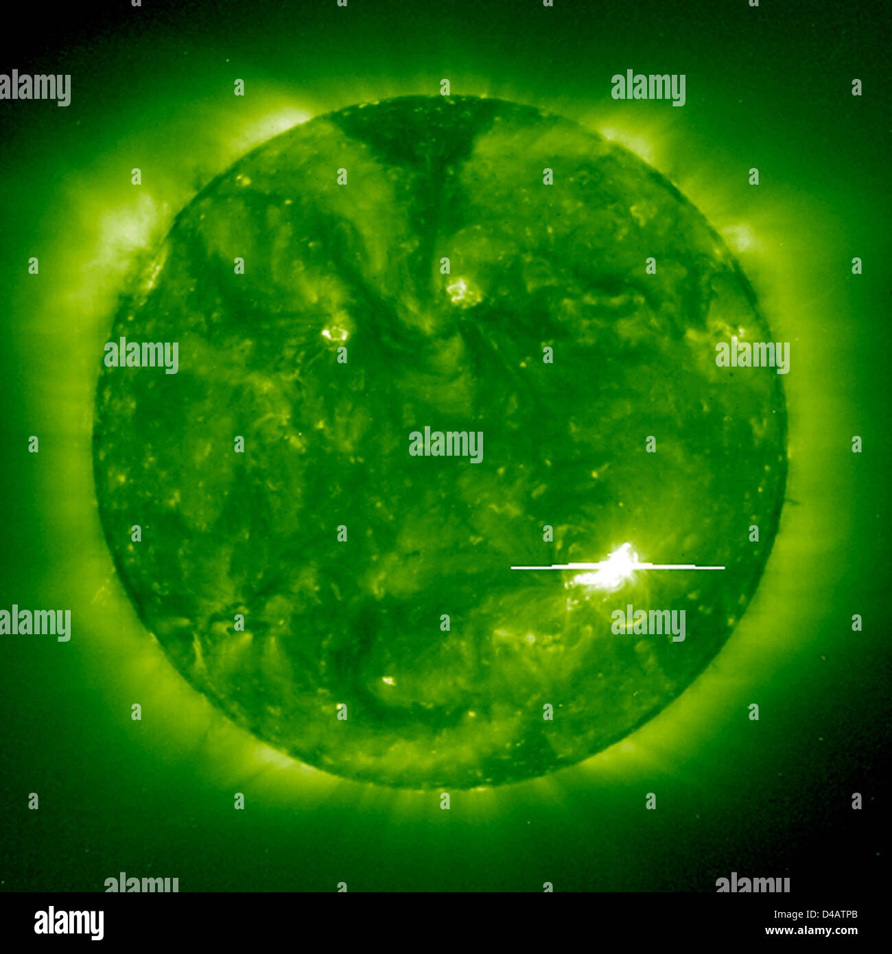 A bright solar flare erupts from the Sun, releasing a burst of energy ...