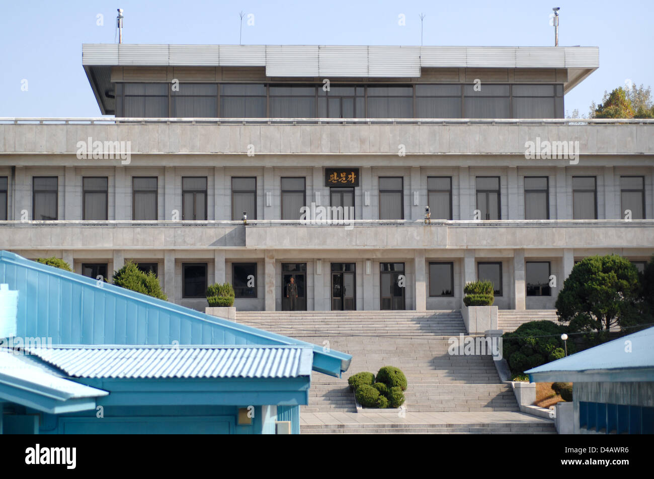 A building at the demarcation line between North Korea (above) and ...