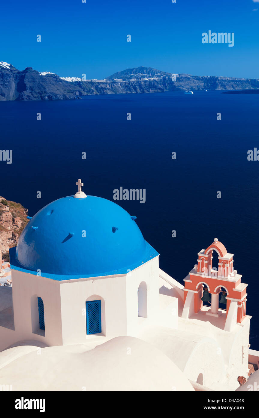 Orthodox church at Oia (Ia) village with Fira town and cruise ships in ...