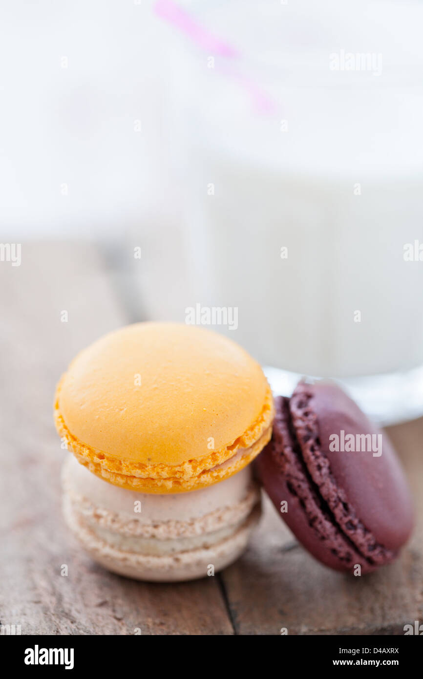 Closeup of three macaroons on wooden table surface Stock Photo - Alamy
