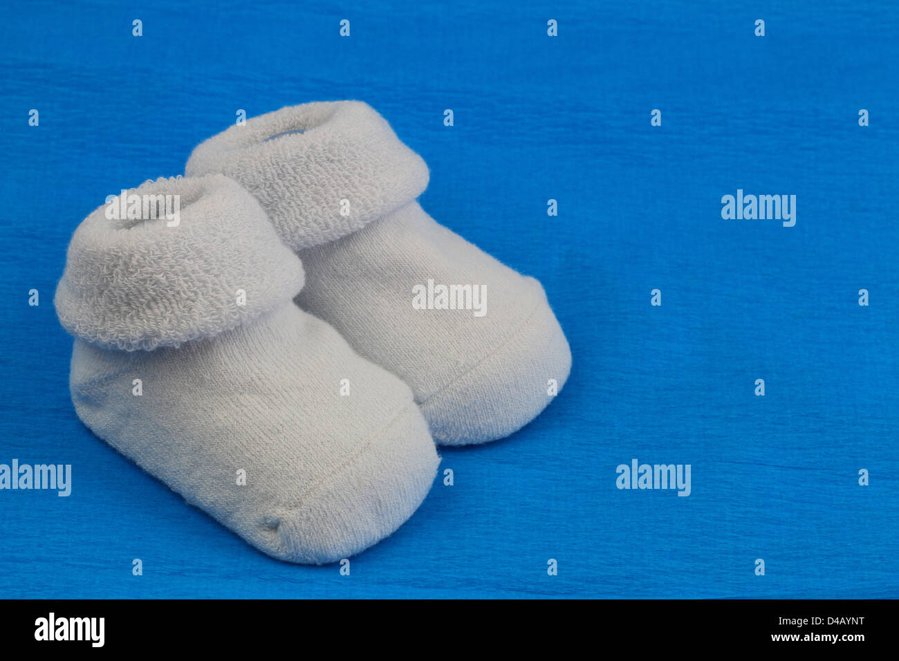 blue baby socks on blue background Stock Photo - Alamy