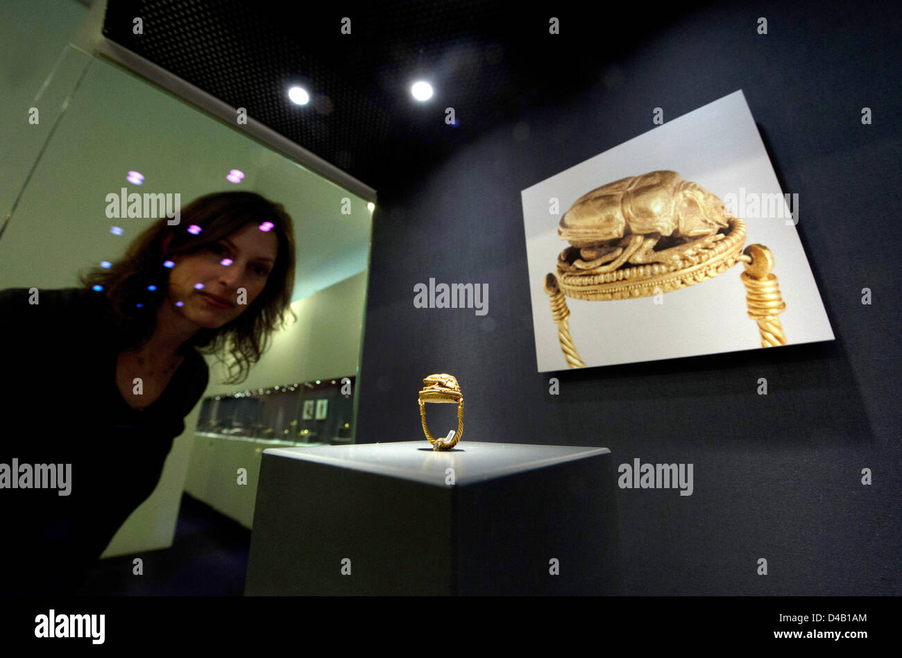 A woman observes a Greek scarab ring from the 4th century BC at a press ...