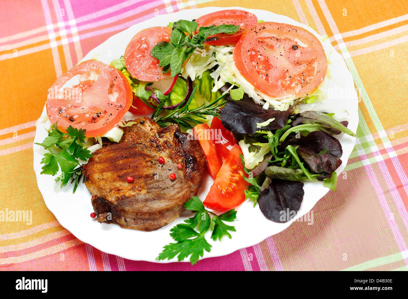 Plate with grilled meat and salad Stock Photo - Alamy