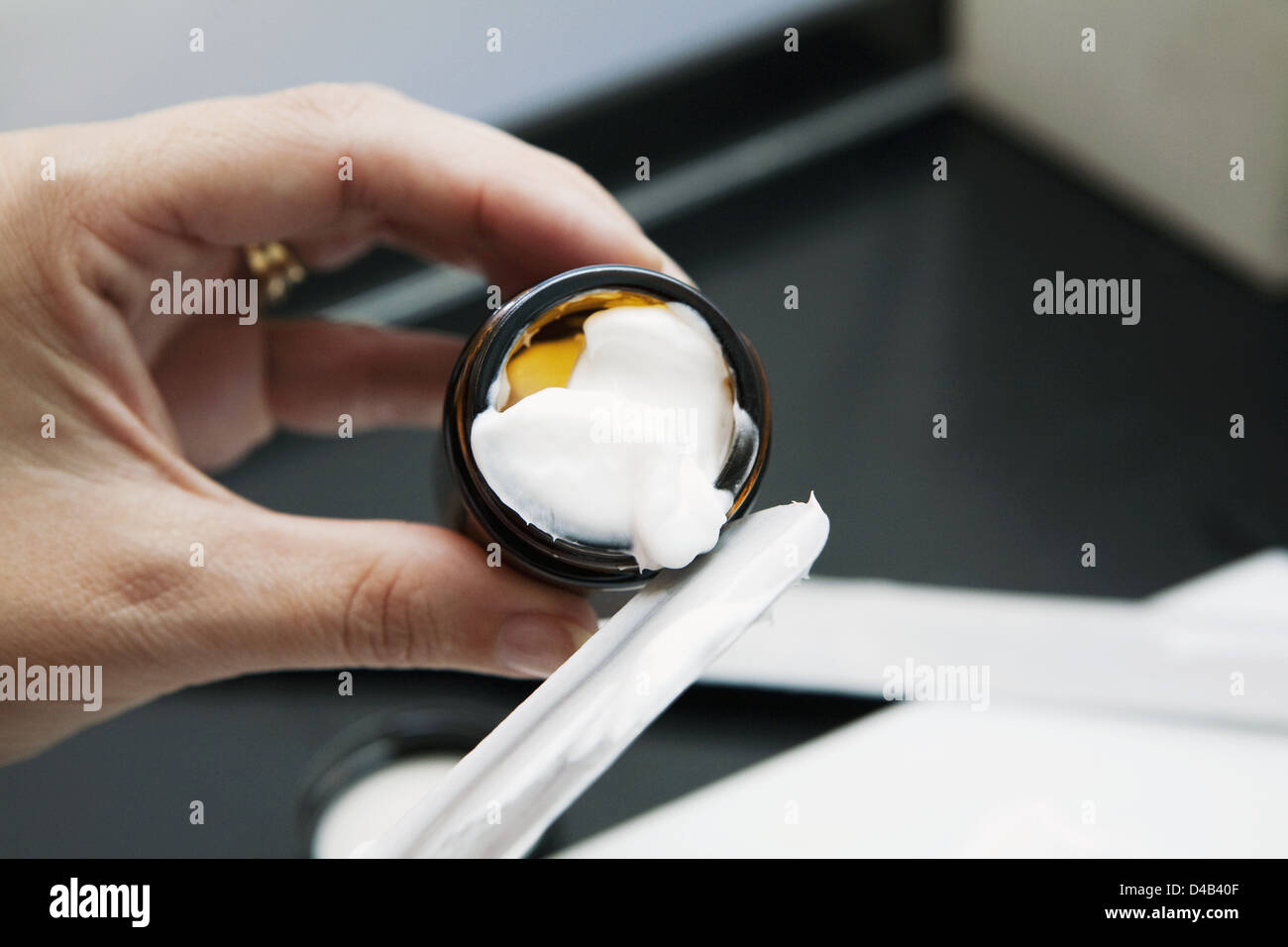 Pharmacist filling bottle with ointment Stock Photo - Alamy