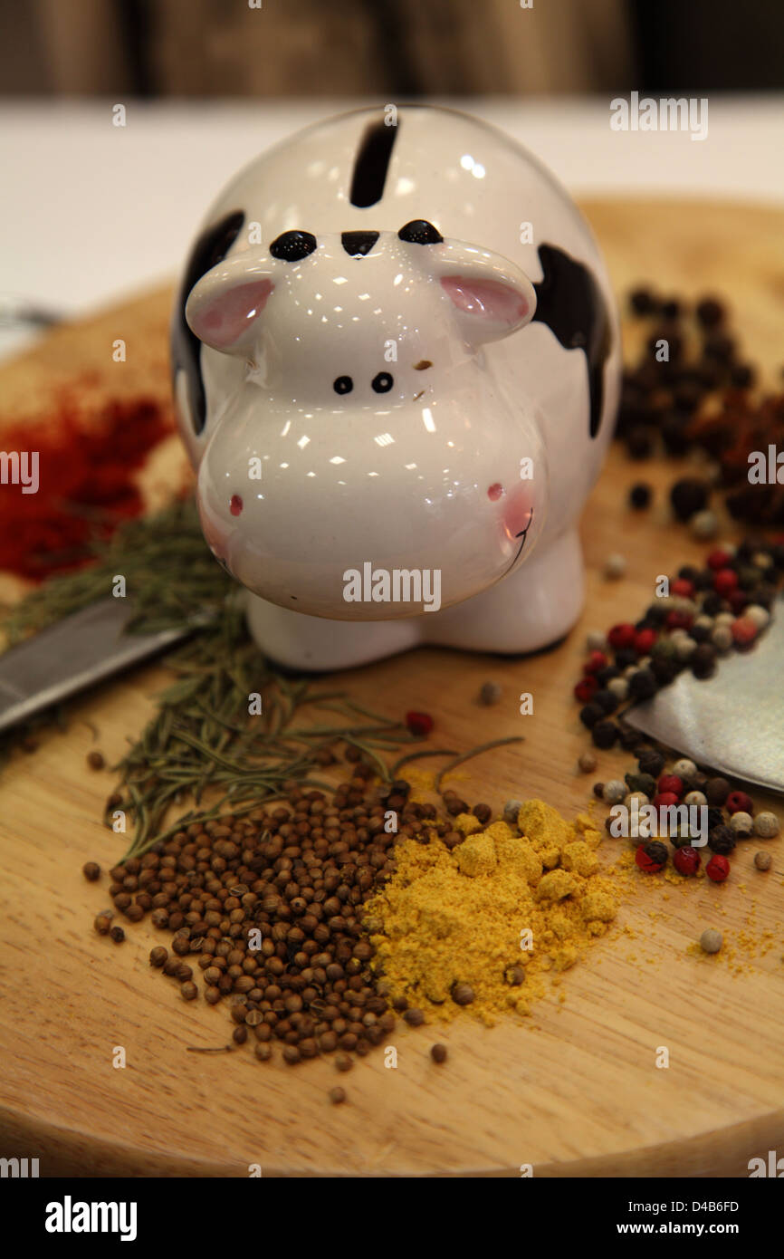 cow of porcelain,on a table,with spices Stock Photo - Alamy