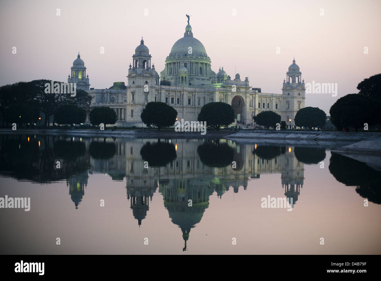 The Victoria Memorial in Kolkata, India is lit by floodlights at dusk ...