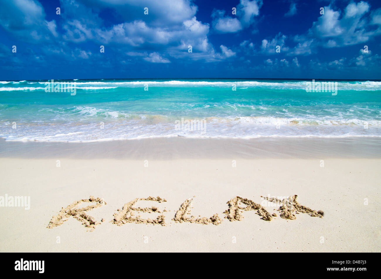 Word Relax on sand beach Stock Photo - Alamy