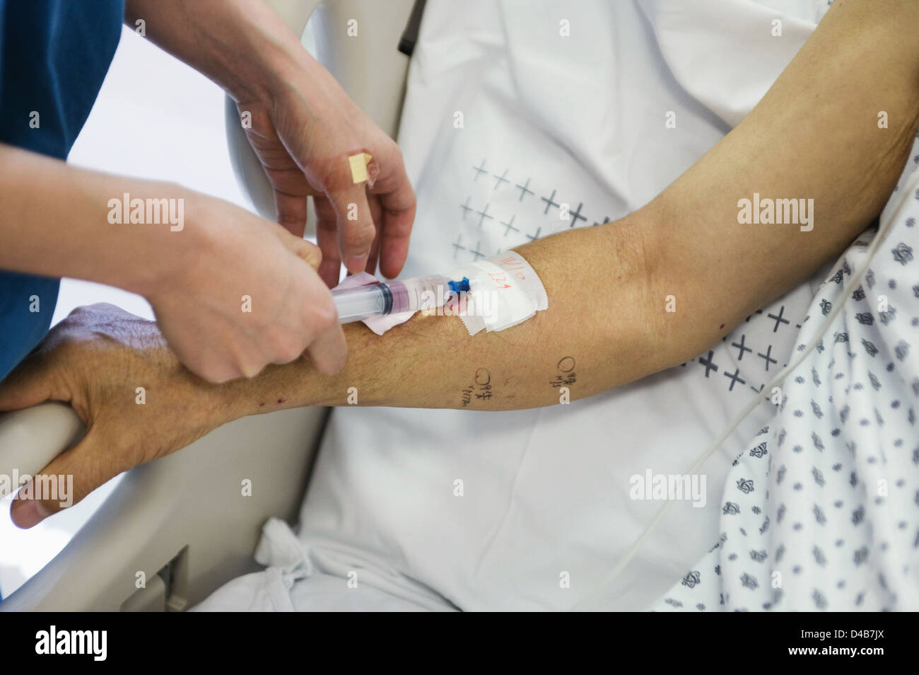 Patient having intravenous drip inserted into arm hi-res stock ...