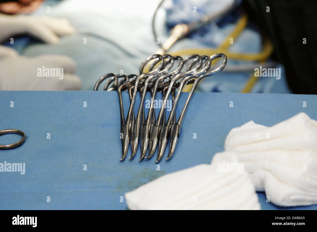 Row of forceps on edge of surgical tools table hi-res stock photography ...