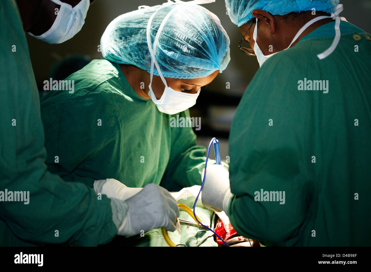 Female surgeon and her assistants operating on patient Stock Photo - Alamy