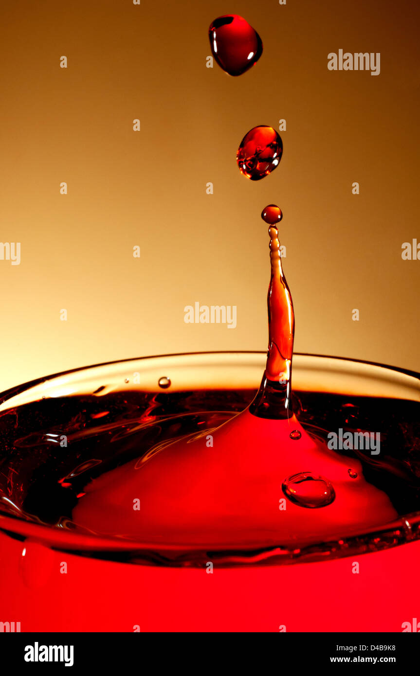 Red water drops in a glass Stock Photo - Alamy