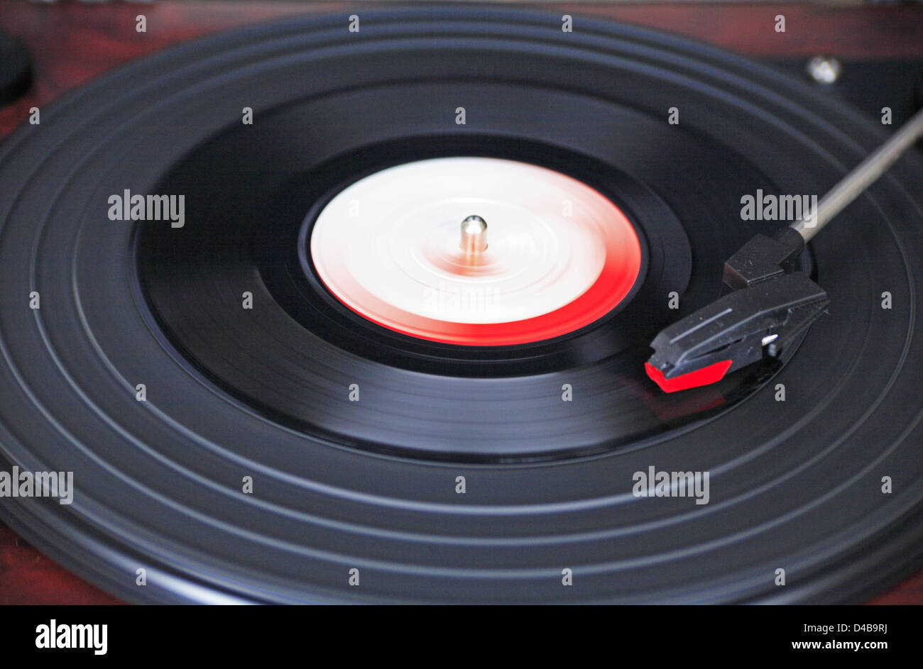 An old vinyl 45 rpm record spinning on a turntable Stock Photo - Alamy