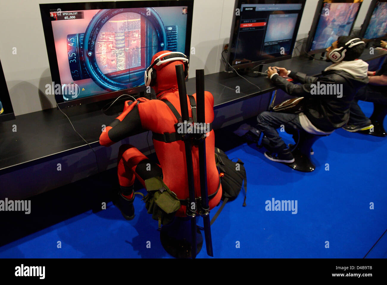A visitor dressed as character Deadpool tries out an unreleased ...