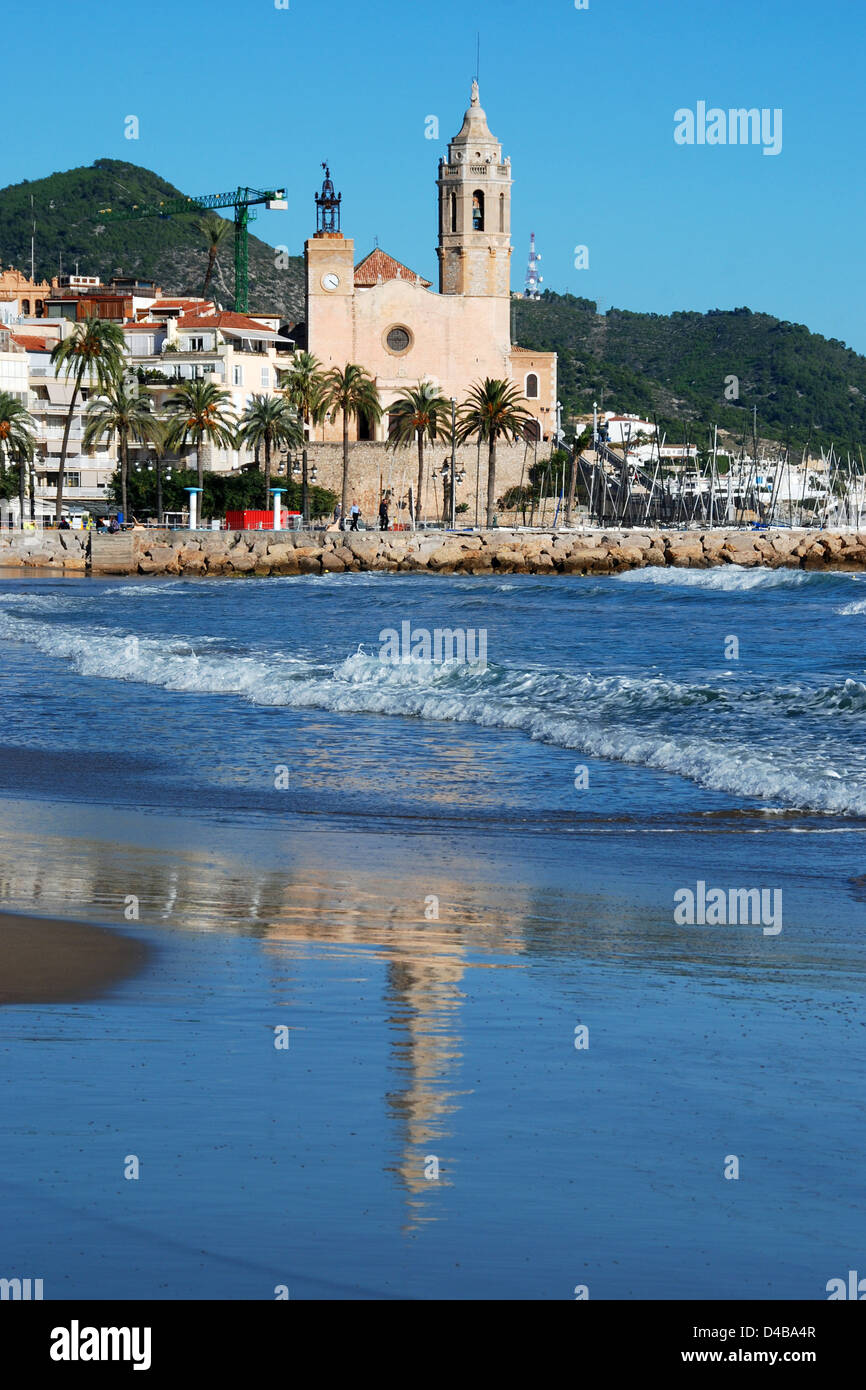 Church of Saint Bartholomew and Saint Tecla reflected in the wet sand ...