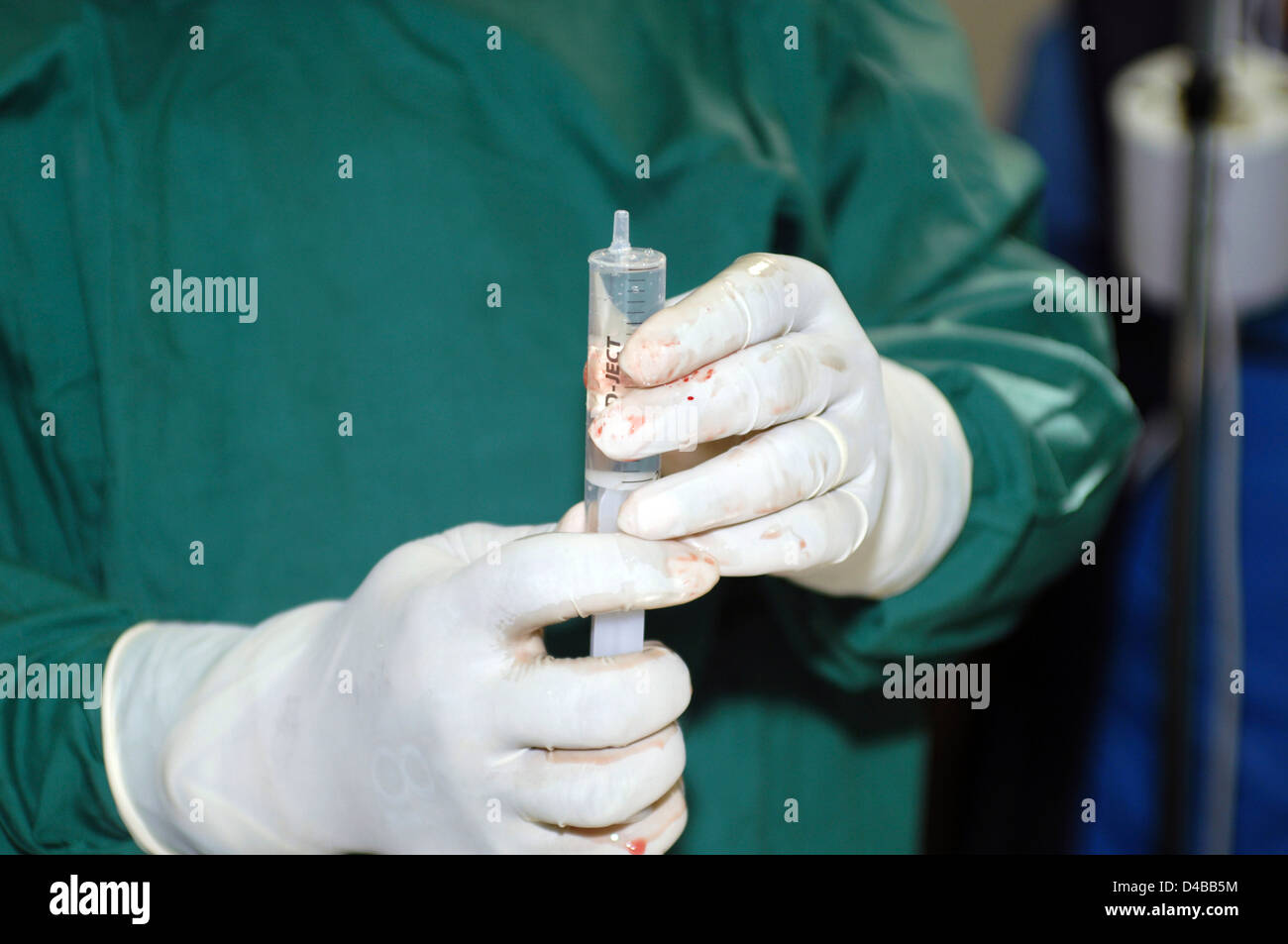The cardiologist prepares a syringe with saline solution during Radial ...